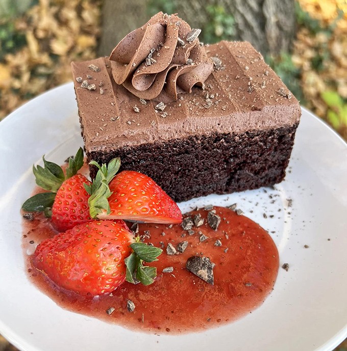 Triple chocolate cake that doesn't just satisfy your sweet tooth—it throws a party for it. Those strawberries are trying to convince you it's healthy. (It's not. Eat it anyway.)
