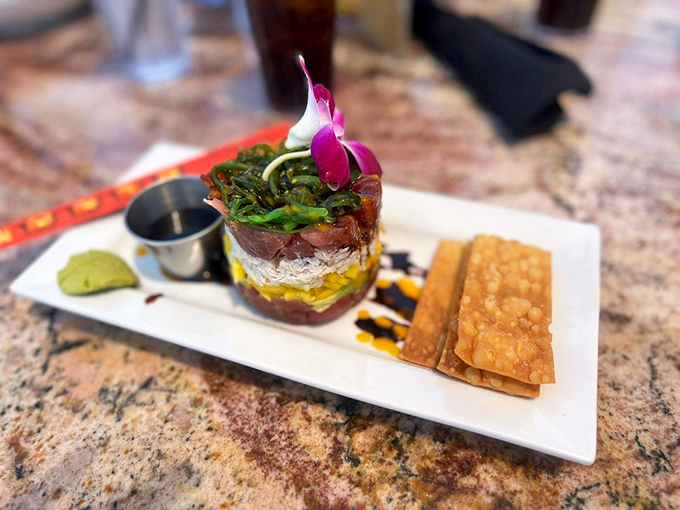 This tuna stack isn't just appetizing &ndash; it's architectural genius with layers of flavor and that orchid garnish saying "I'm fancy but approachable."