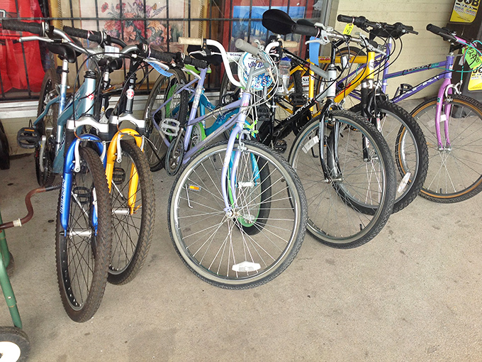A fleet of pre-loved bicycles waiting for their next adventure. One person's outgrown Schwinn is another's ticket to freedom.