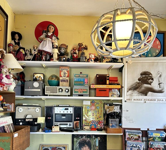 The shelf displays a time warp of vintage electronics, dolls, and memorabilia that would make any Baby Boomer exclaim, "I had that!"