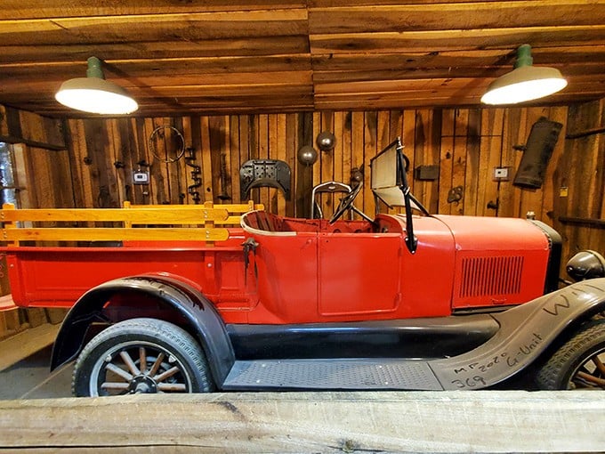 This vintage red pickup isn't just transportation&mdash;it's American history on wheels. Parked indoors, it's both merchandise and museum piece in this wood-paneled showcase.