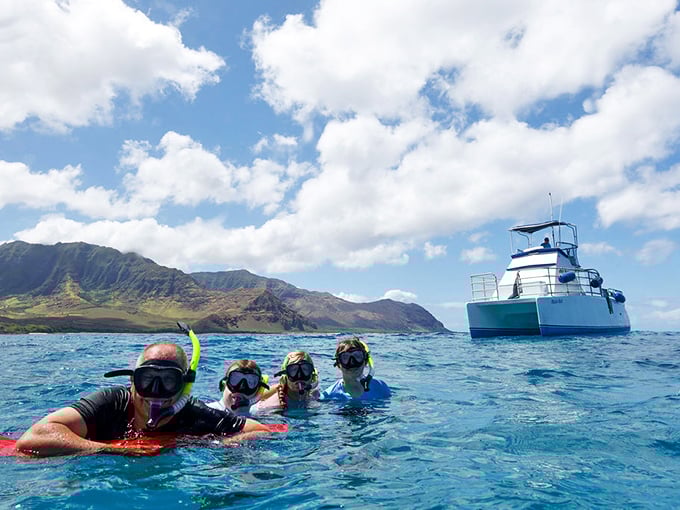 Nothing says "I'm really on vacation" like floating in Waianae's clear waters with snorkels and a catamaran waiting nearby.