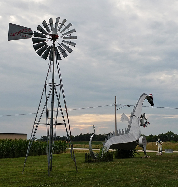 The old windmill watches over the dragon, proving that even traditional Midwest landmarks appreciate good company with flair.