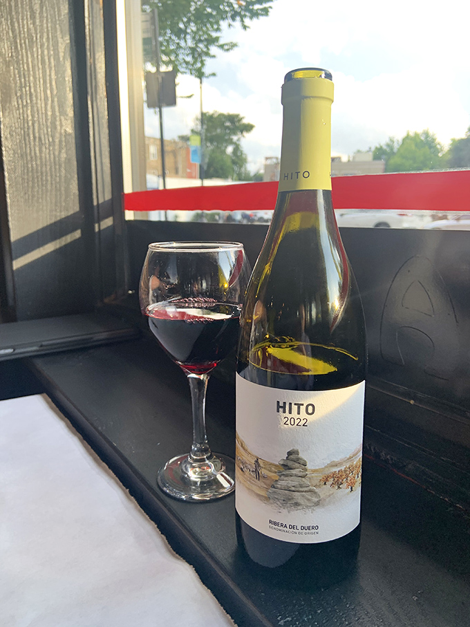 A glass of red wine by the window&mdash;the perfect companion for watching Lincoln Avenue life unfold while plotting your next pizza move.