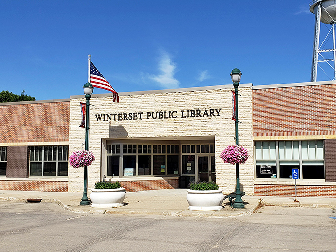 The Winterset Public Library welcomes bibliophiles with hanging flower baskets and the promise of literary treasures within its limestone and brick walls.