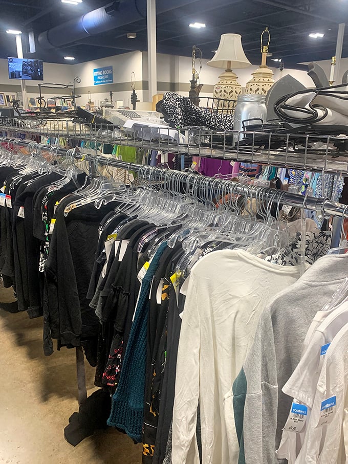 Clothing racks stretch toward the horizon like a textile landscape, each hanger a tiny billboard advertising possibility.