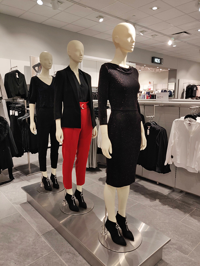 Elegant mannequins sporting cocktail attire that says "Yes, I'm fabulous" while the price tags quietly add "...and financially responsible."