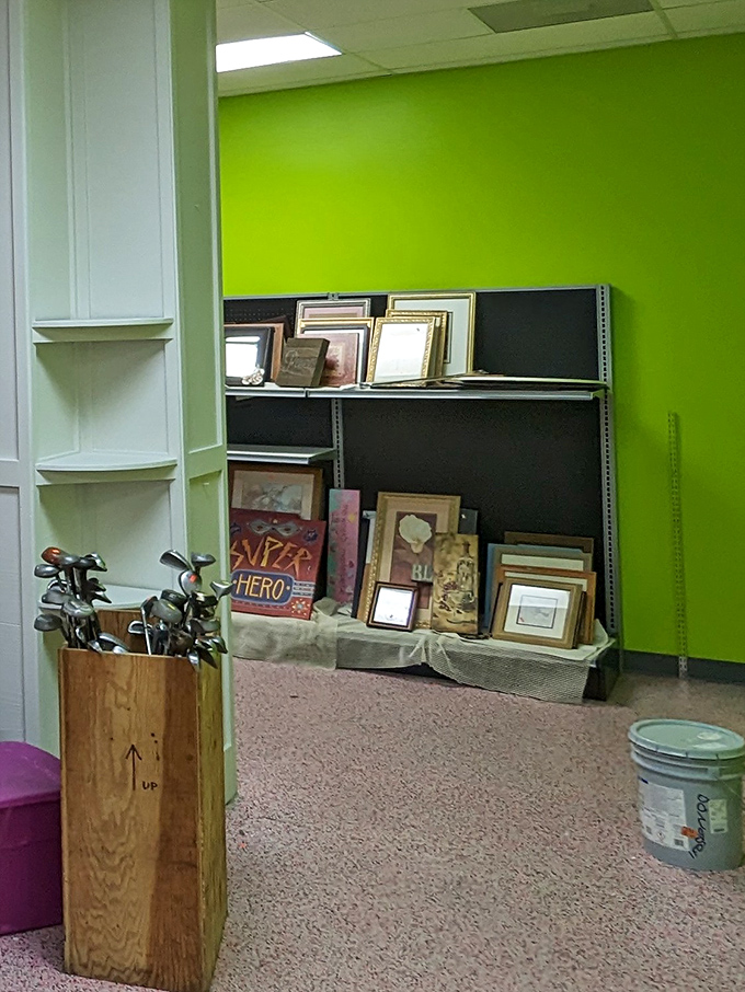 Art in waiting against that eye-popping lime green wall. Someone's forgotten frames and golf clubs huddle together like old friends at a reunion.