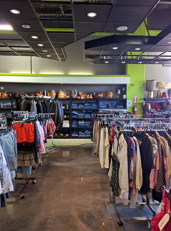 The clothing section is organized with military precision. Lime green accents pop against the industrial ceiling, creating an unexpectedly stylish shopping experience.