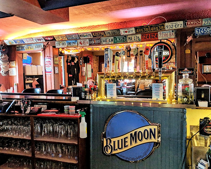 The bar area, where license plates meet Blue Moon signage, creating that perfect "I've discovered something authentic" vibe that makes great roadhouses special.