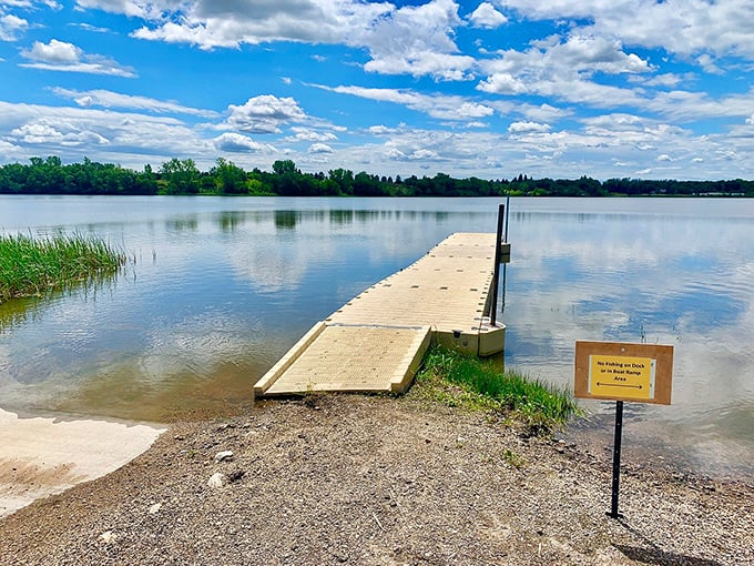 The boat dock stretches into the lake like an invitation, practically whispering, "Come on in, the water's just fine!"