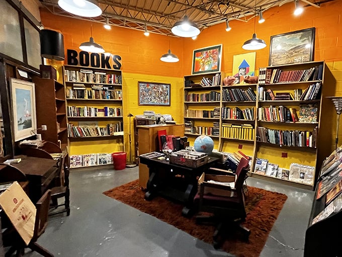 The book nook's vibrant orange walls house literary treasures from bygone eras. That vintage desk has probably witnessed the writing of countless shopping lists.