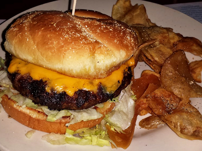 A burger that doesn't need fancy toppings to impress—just perfectly seasoned beef, melted cheese, and house-made chips that shatter with satisfying crispness.