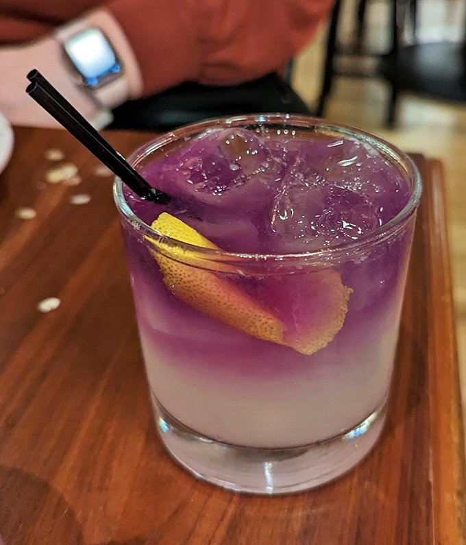 This isn't just a cocktail – it's a purple-hued magic potion that transforms an ordinary evening into something worth remembering.