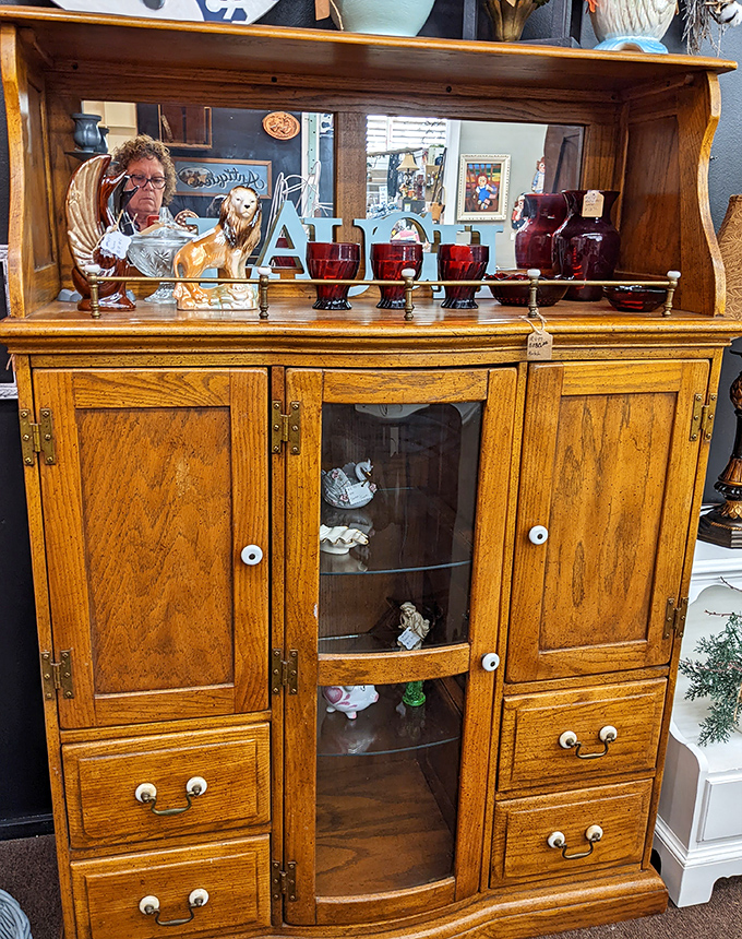 Oak cabinets with glass doors and intricate hardware showcase the craftsmanship modern furniture just can't replicate anymore.