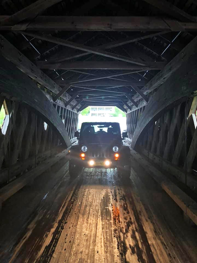 Even modern vehicles still rumble through this historic passage. That Jeep driver is experiencing a time-travel moment without needing a DeLorean.