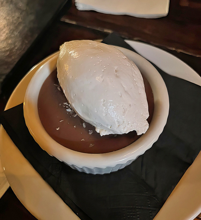 Chocolate pot de cr&egrave;me with a cloud of whipped cream &ndash; proof that heaven might actually be a dessert menu item all along.