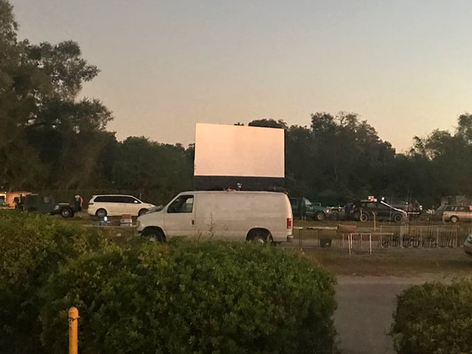 The humble ticket booth stands guard at the entrance, its yellow and red paint scheme a cheerful welcome to movie-goers seeking nostalgic thrills.