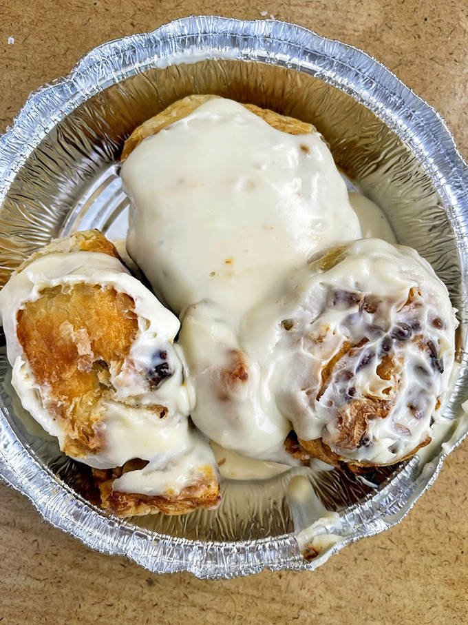 Cinnamon rolls that could make a pastry chef weep, swimming in vanilla cream cheese frosting that doesn't know the meaning of restraint.
