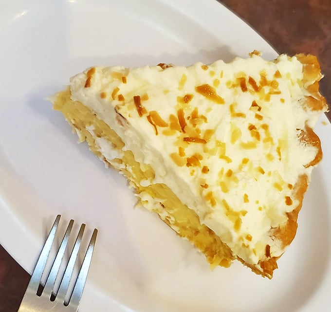 A slice of coconut cream pie that would make even the most dedicated dieter throw caution to the wind. That golden topping is calling your name.