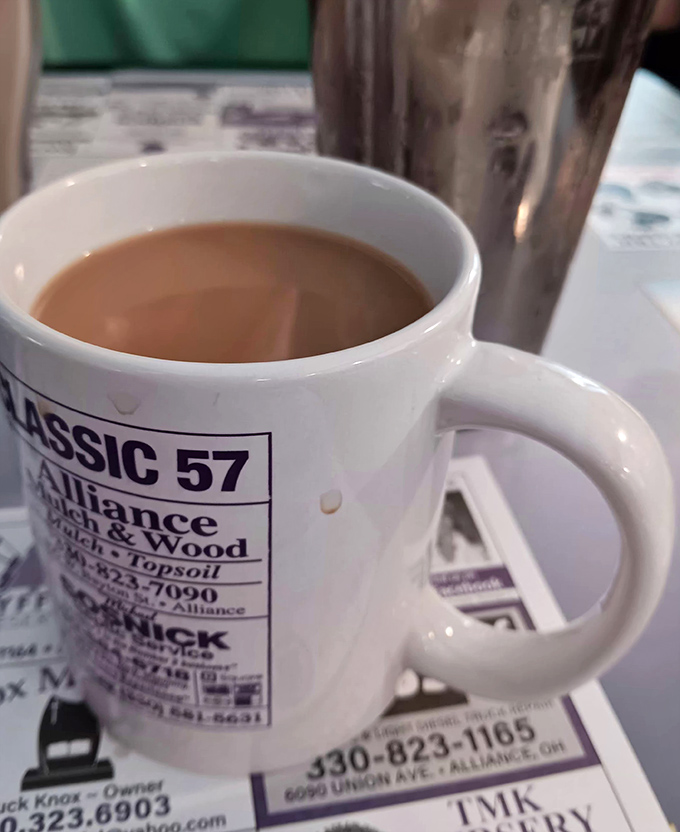 The humble coffee mug&mdash;advertising local businesses while delivering the lifeblood of early risers. In diners like this, refills aren't just offered, they're practically mandatory. 