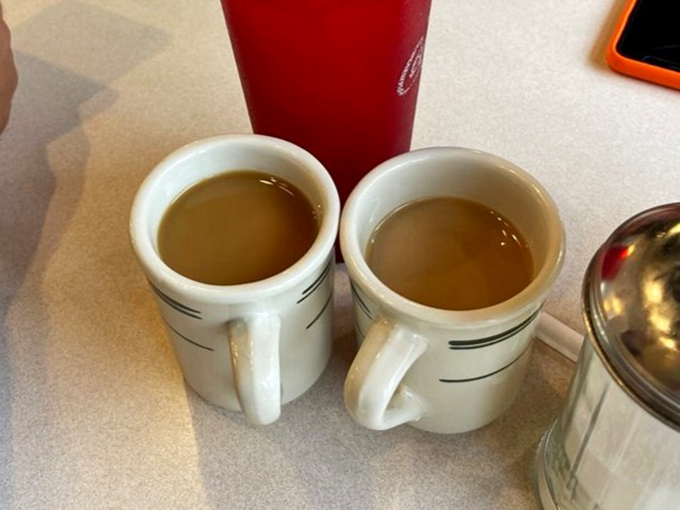 Two cups of diner coffee&mdash;the kind that doesn't need fancy names or elaborate preparation, just honest warmth in ceramic mugs.