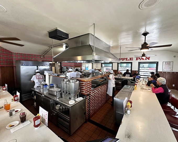 Behind this U-shaped counter, culinary choreography unfolds as cooks perform their well-rehearsed burger ballet.