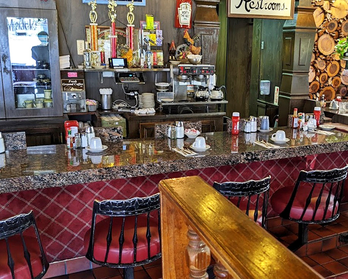 The counter seats &ndash; where breakfast philosophers gather, coffee cups in hand, watching short-order magic happen beneath those vintage trophies.