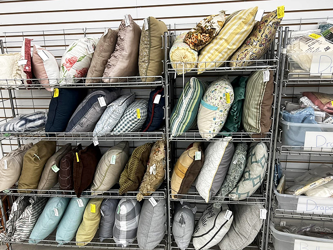 Decorative pillows stacked with military precision, a textile rainbow waiting to transform someone's couch from drab to fab.