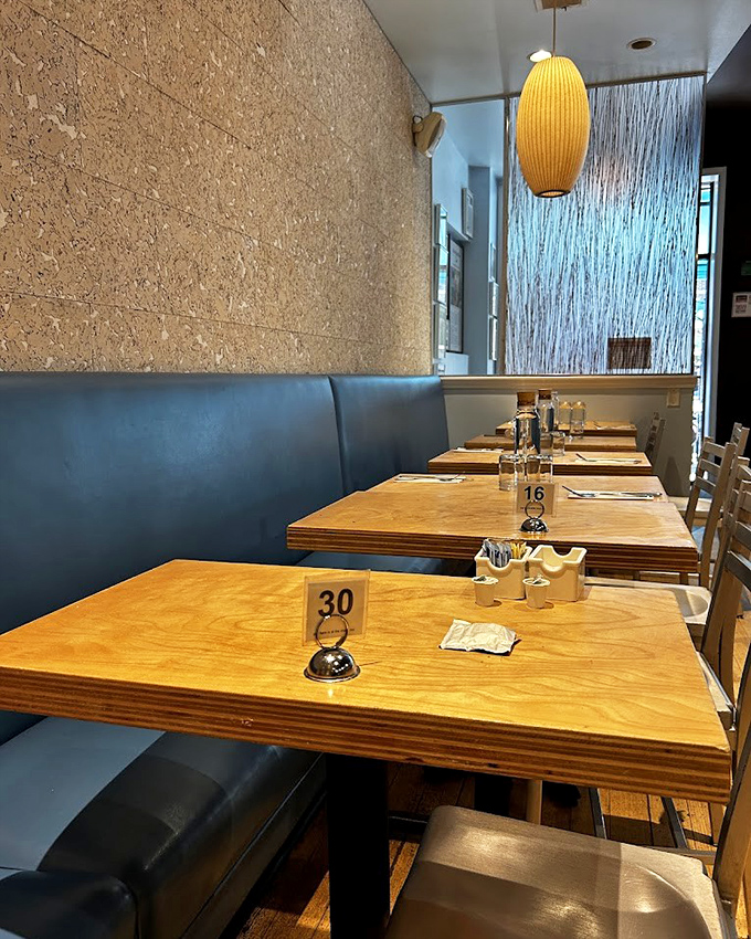 Blue banquettes and wooden tables create the perfect backdrop for morning conversations or solo newspaper reading. Table numbers optional.