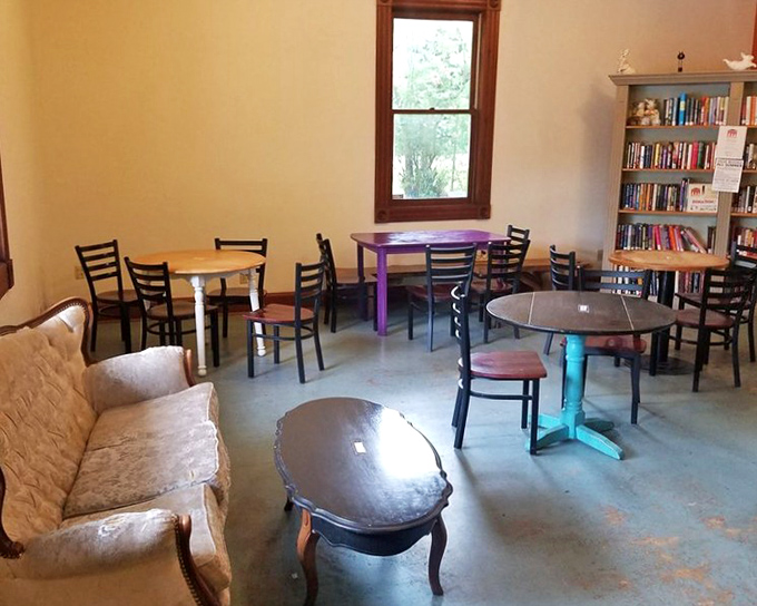 Mismatched tables in cheerful colors create the ultimate "stay awhile" vibe. This isn't just a bakery—it's Aurora's living room, complete with books and conversation.