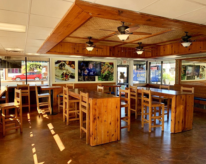 Wooden communal tables invite strangers to become temporary dining companions, united by the universal language of "pass the salsa, please."