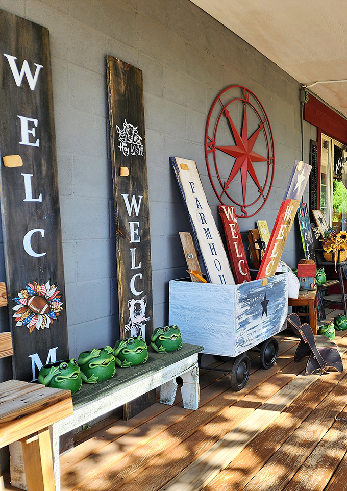 Rustic welcome signs and cheerful frog planters greet visitors on the porch. Country charm with a wink and a smile.