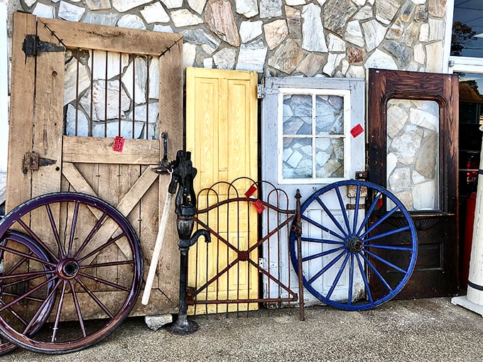 Vintage doors and wagon wheels create an architectural salvage dream – your renovation project just found its missing piece.