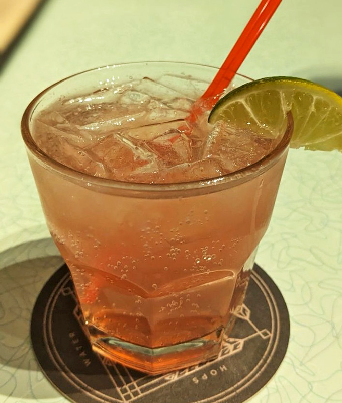 A refreshing pink cocktail with lime that whispers, "The day is done, friend—time to unwind in this Kansas City hideaway."
