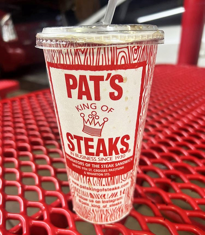 That cup isn't just holding a beverage—it's providing the necessary counterbalance to the magnificent flavor assault that is a proper Philly cheesesteak.