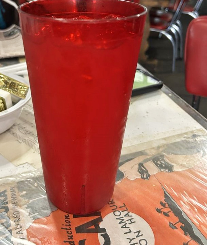 That vibrant red drink isn't just refreshing &ndash; it's the unofficial state beverage of summer afternoons in the Ozarks, condensation beading on the glass like morning dew.