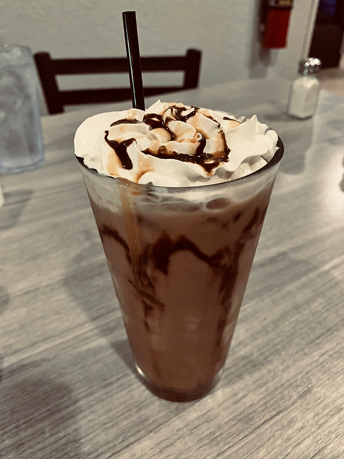 Not just a milkshake, but a drinkable dessert masterpiece. That chocolate-drizzled whipped cream mountain deserves its own zip code.