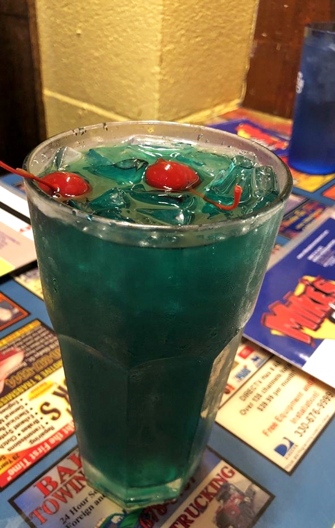 Electric blue cocktail with cherry garnishes&mdash;it's what would happen if a tropical vacation and a college party planned a drink together.