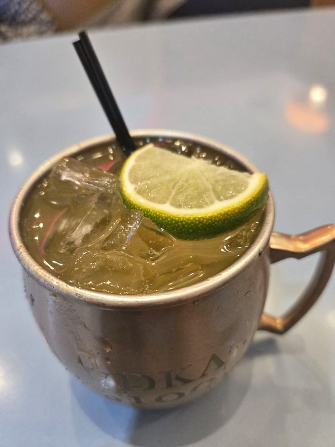 The Moscow Mule arrives in its traditional copper mug, looking like it just stepped out of a cocktail fashion magazine.