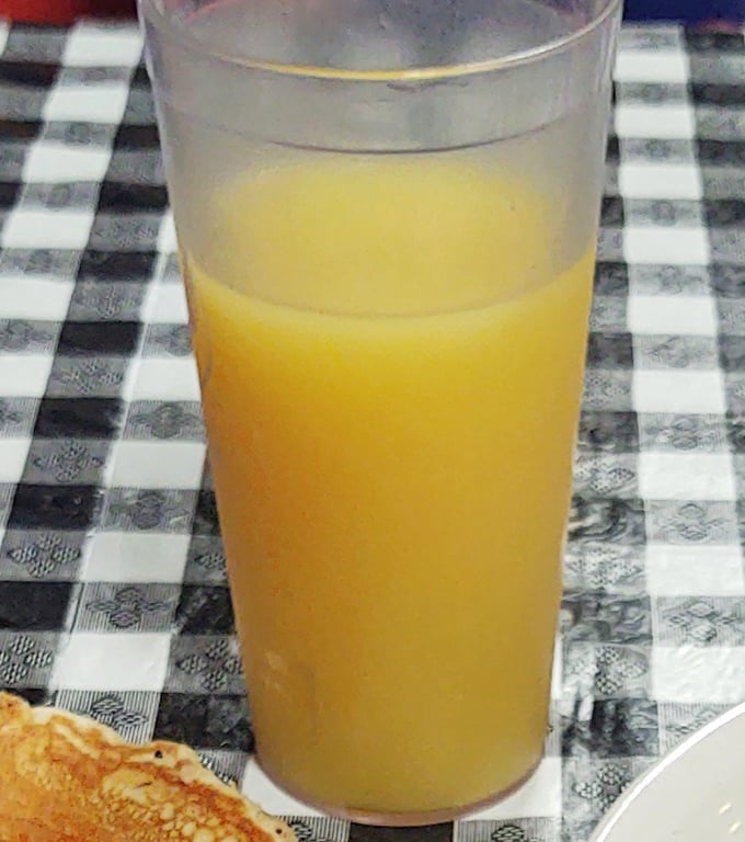 Fresh orange juice in a no-nonsense glass&mdash;because sometimes the simple pleasures are what really wake you up in the morning.