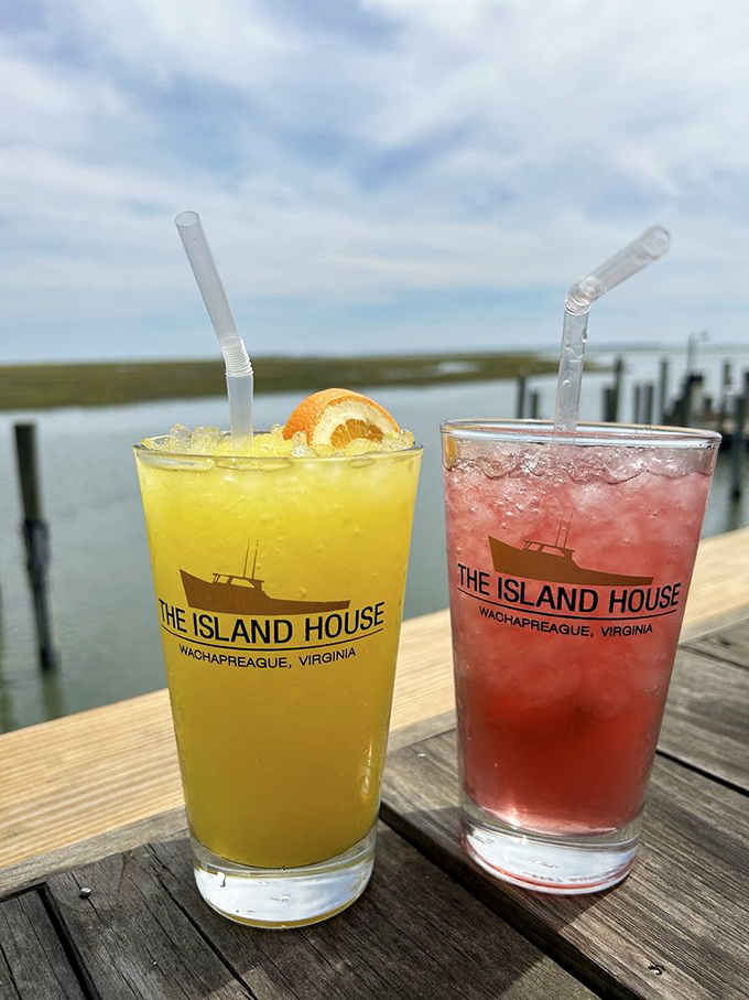 Cocktails with a view that makes plastic cups feel like crystal. That yellow concoction might just be liquid sunshine in disguise.