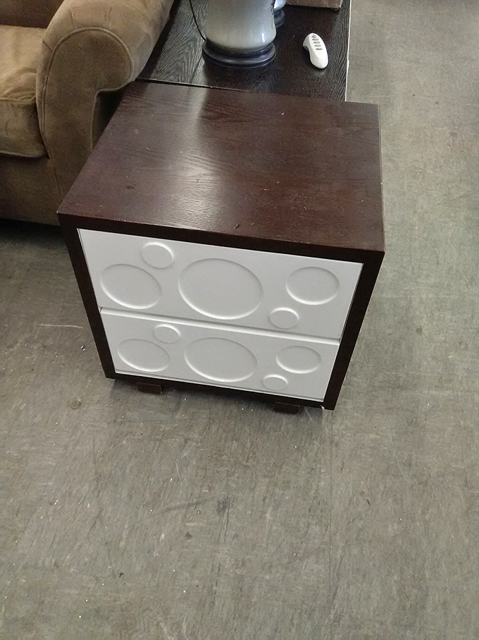 Mid-century meets modern in this quirky end table. The circular pattern front panels are practically winking at design enthusiasts.