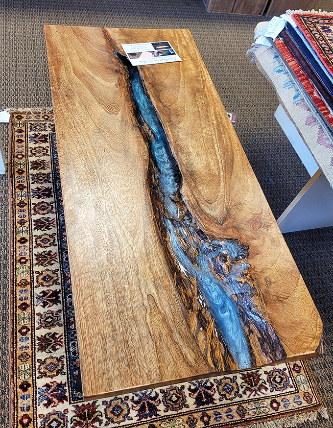 This stunning wood and epoxy river table belongs in an upscale gallery, not sandwiched between thrift store carpets. Someone's about to score the deal of the century.