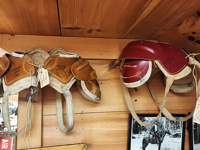 Vintage football shoulder pads hanging like retired warriors, reminding us when sports equipment was leather, not space-age polymers.