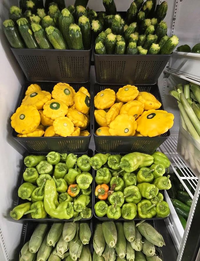 Farm-fresh produce shares space with vintage treasures. Those yellow pattypan squash look like they jumped straight out of a country cookbook.