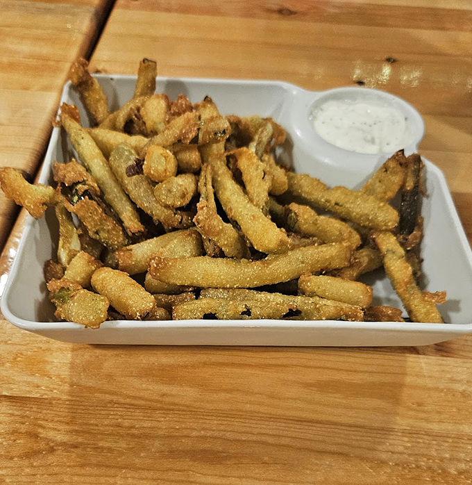 Deep-fried pickle fries &ndash; tangy, crunchy, and utterly addictive. The kind of appetizer that disappears before anyone remembers to take a photo.