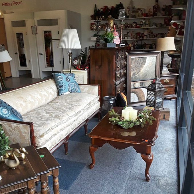 Vintage furniture vignettes create little islands of possibility, each piece whispering stories of dinner parties and family gatherings from decades past.