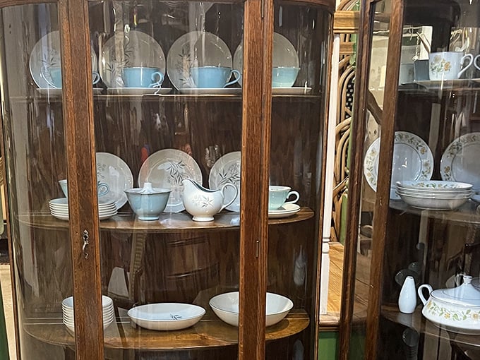 Delicate mid-century china displayed in its natural habitat &ndash; a vintage cabinet that's probably witnessed more dinner parties than a 1950s etiquette book.