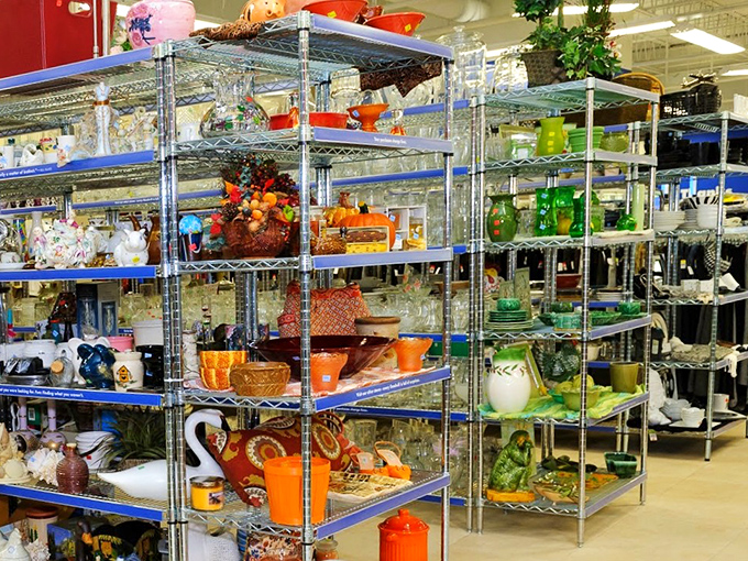 Shelves of glassware organized by color create an impromptu art installation. One person's castoffs become another's color-coordinated kitchen statement.